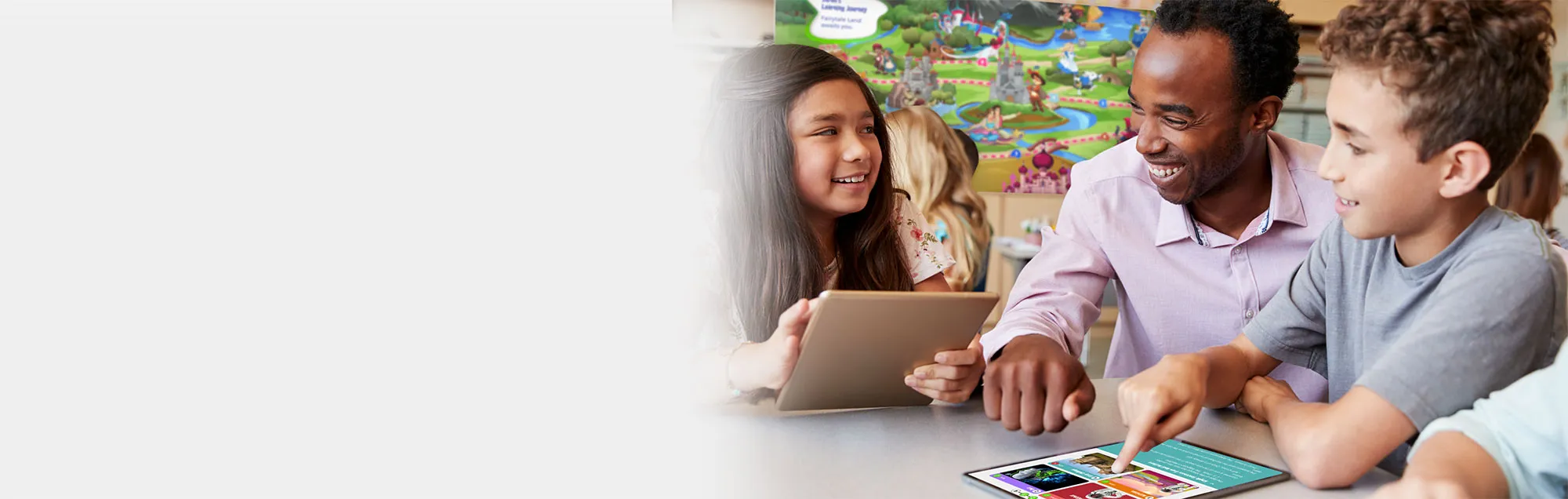 Smiling Kids Hi fiving in classroom with Writer's Toolbox on Laptops